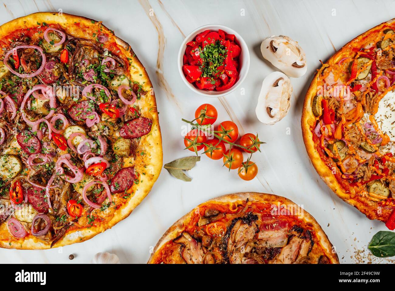 A top view of various tasty pizzas and spices Stock Photo - Alamy