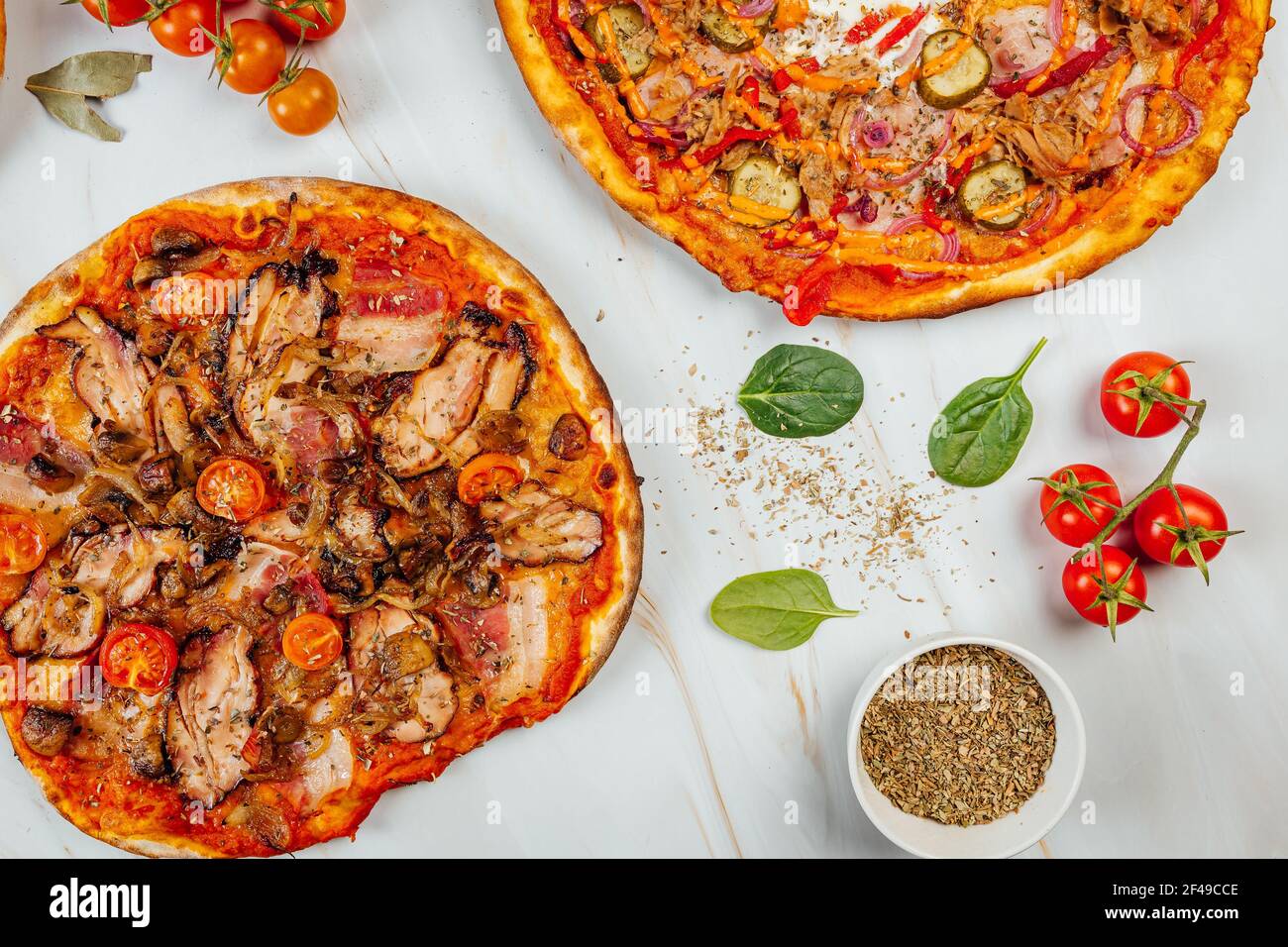 A top view of various tasty pizzas and spices Stock Photo - Alamy