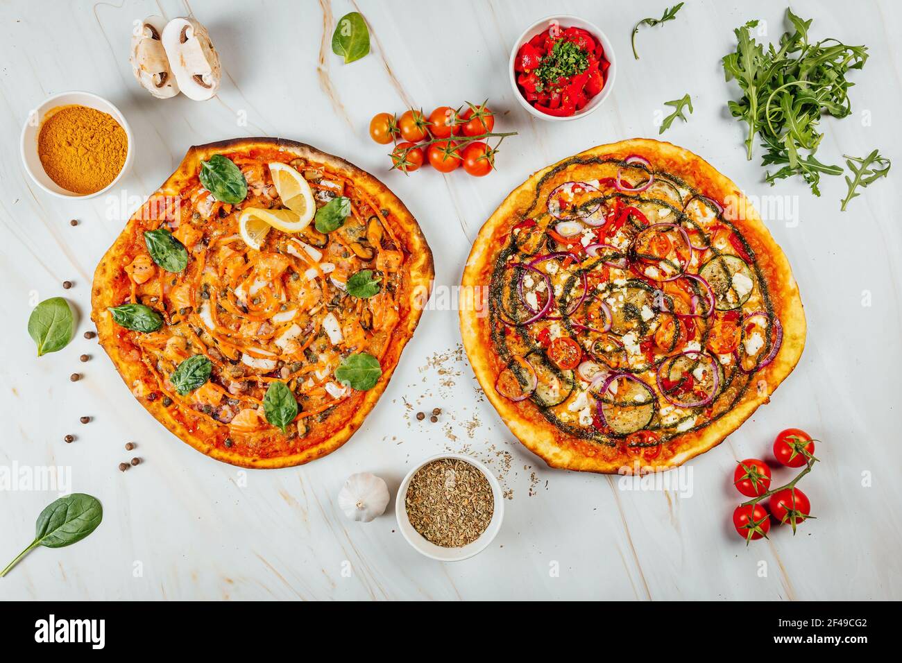 A top view of various tasty pizzas and spices Stock Photo - Alamy