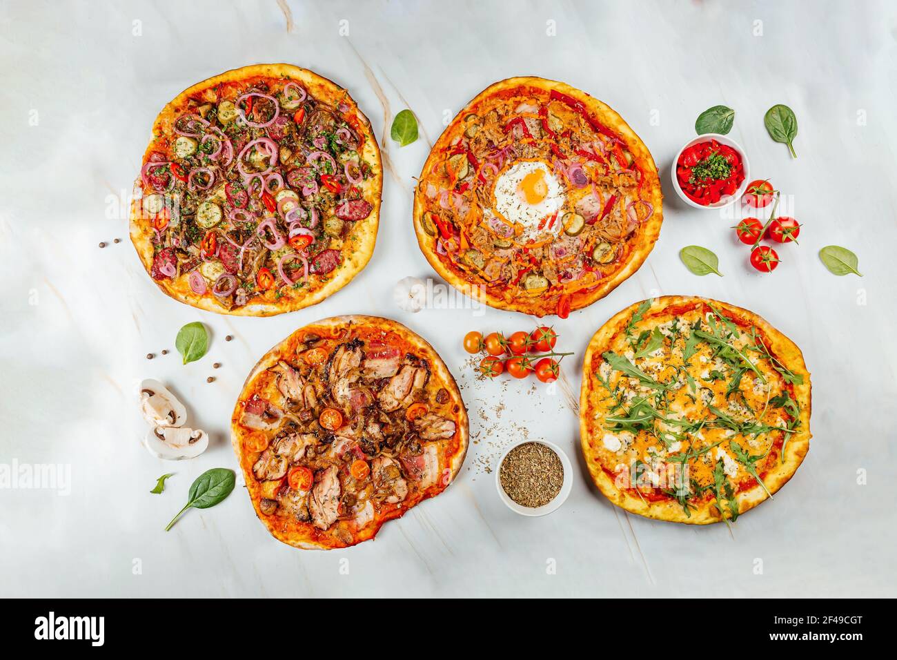 A top view of various tasty pizzas and spices Stock Photo - Alamy