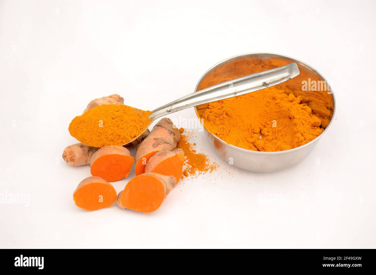 the sliced turmeric with spoon bowl powder isolated on white background ...