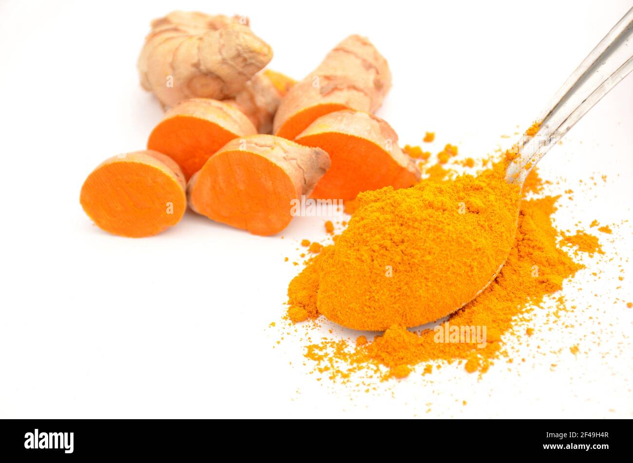the sliced turmeric with spoon bowl powder isolated on white background ...
