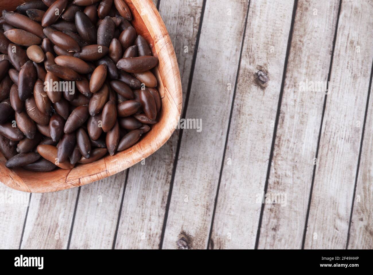 Bowl of brazilian baru nuts over wooden table with room for text Stock ...