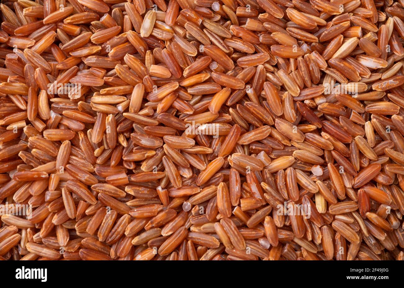 Closeup, top view of whole grain red rice. Food backdrop Stock Photo ...