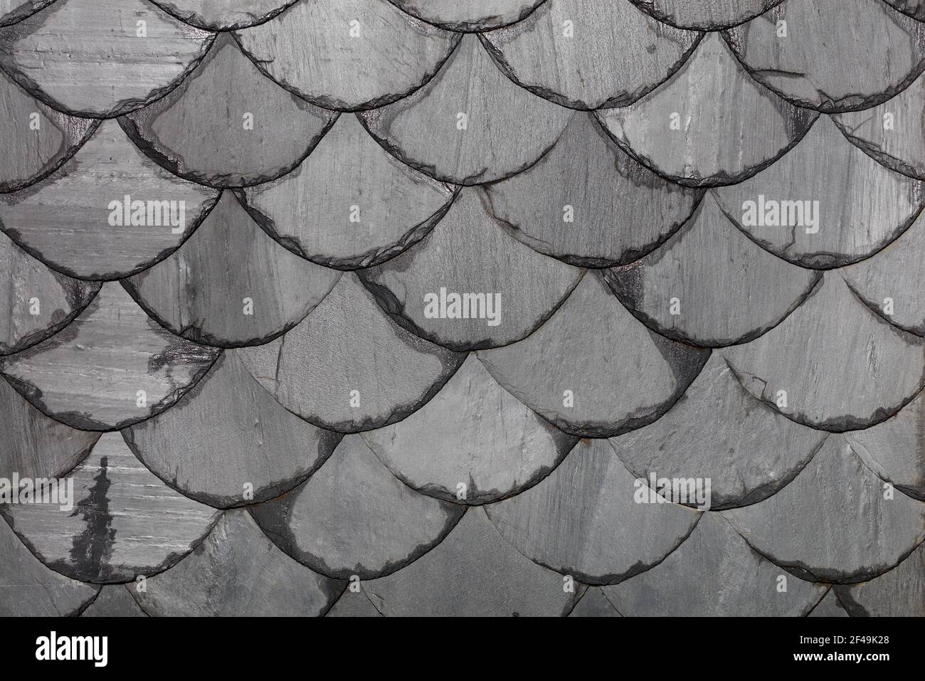 The roof is made of gray slate slabs in the shape of fish scales ...