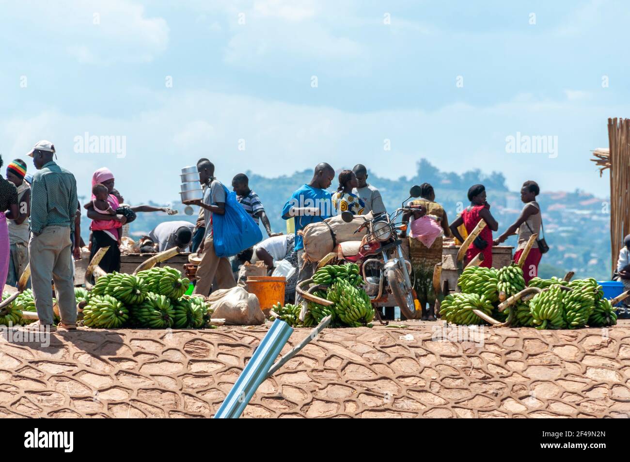 People wait for a boat to transport them across the lake at Ggaba Beach ...