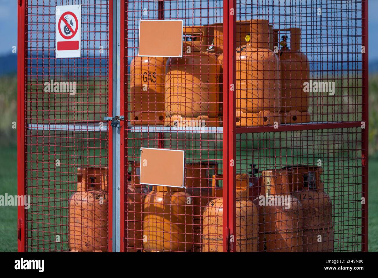 A closeup of a gas storage cage with cylinders Stock Photo - Alamy