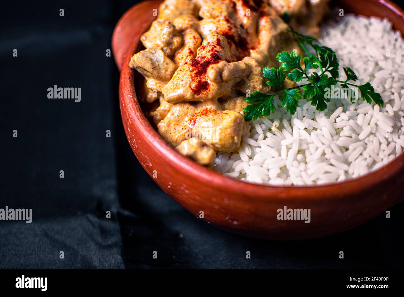 A closeup of traditional Indian spicy lamb food with basmati rice in a ...