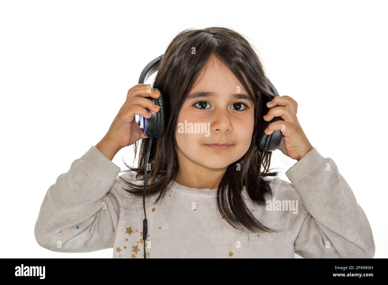 Little girl taking off the headset while looking into the camera Stock ...