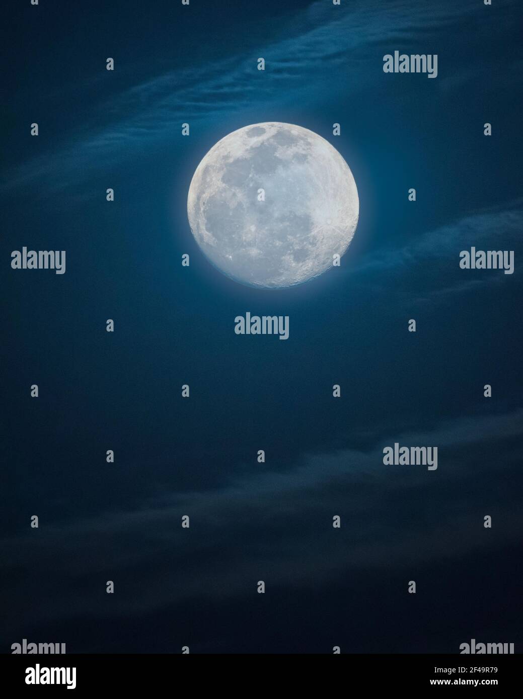 A vertical shot of the bright full moon shining in the night sky Stock ...