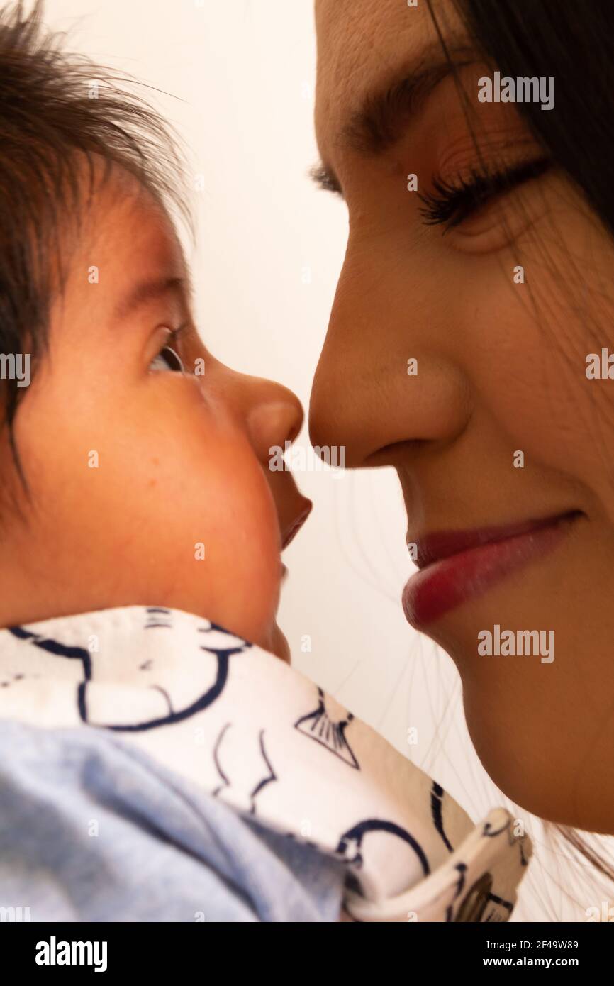 beautiful portrait of a young hispanic mother with her newborn baby ...