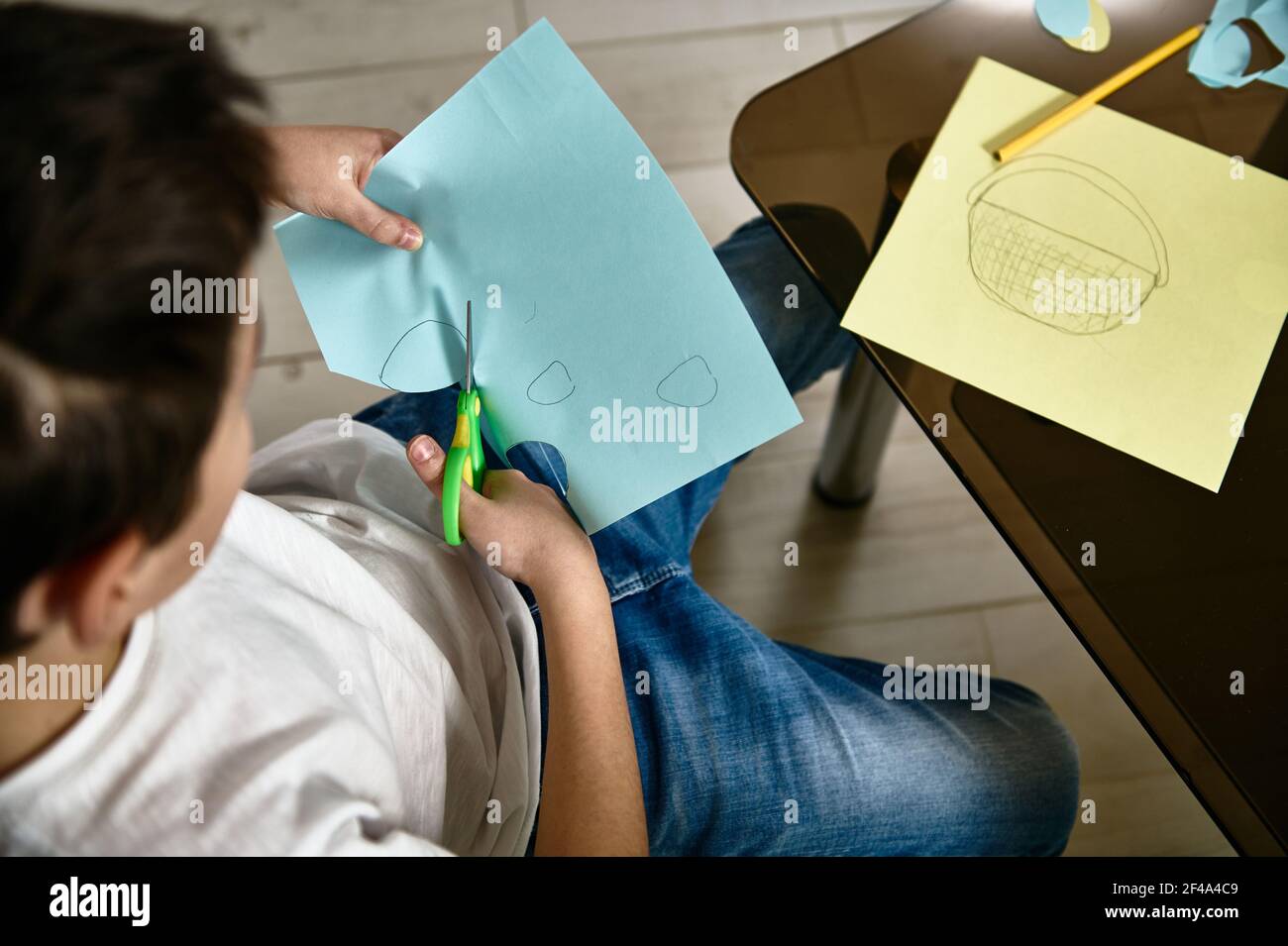 Elementary boy cutting paper scissors hi-res stock photography and ...
