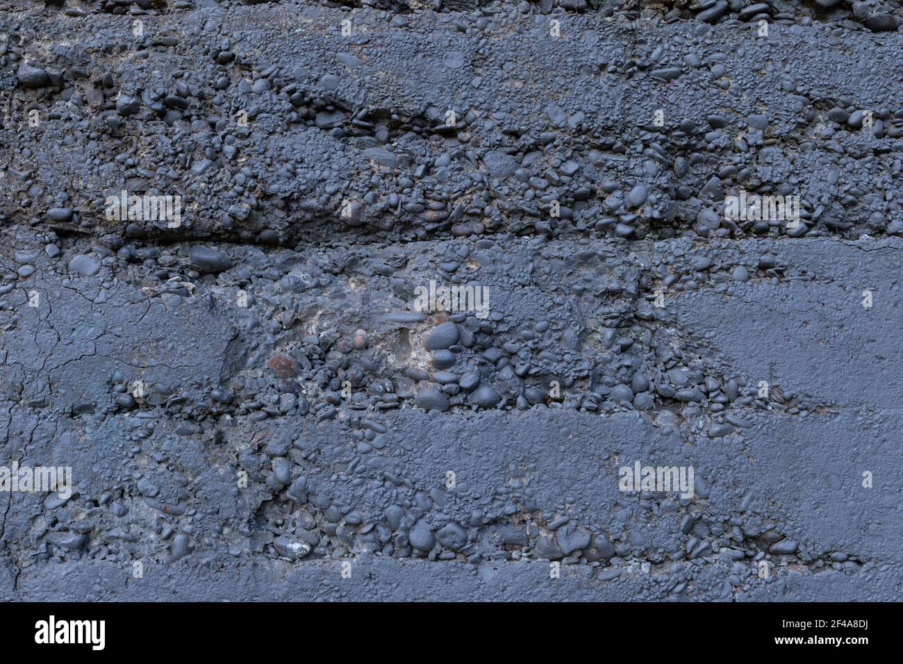 Cracked and crumbling concrete and stone aggregate wall texture painted ...