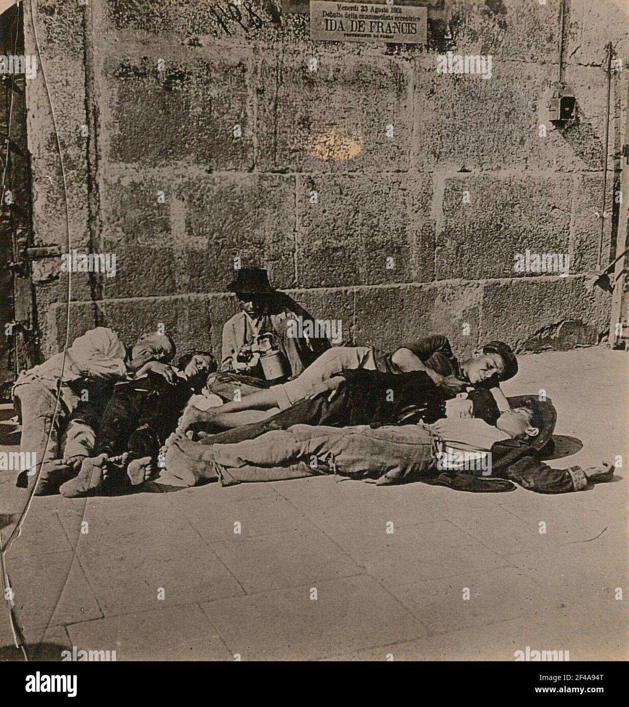 Italy. Naples. Men sitting on the ground, lying Stock Photo - Alamy