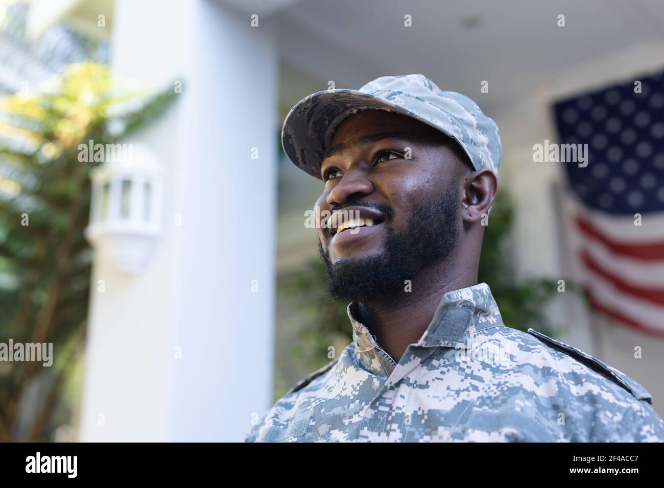 Portrait of african american male soldier standing in front of american ...