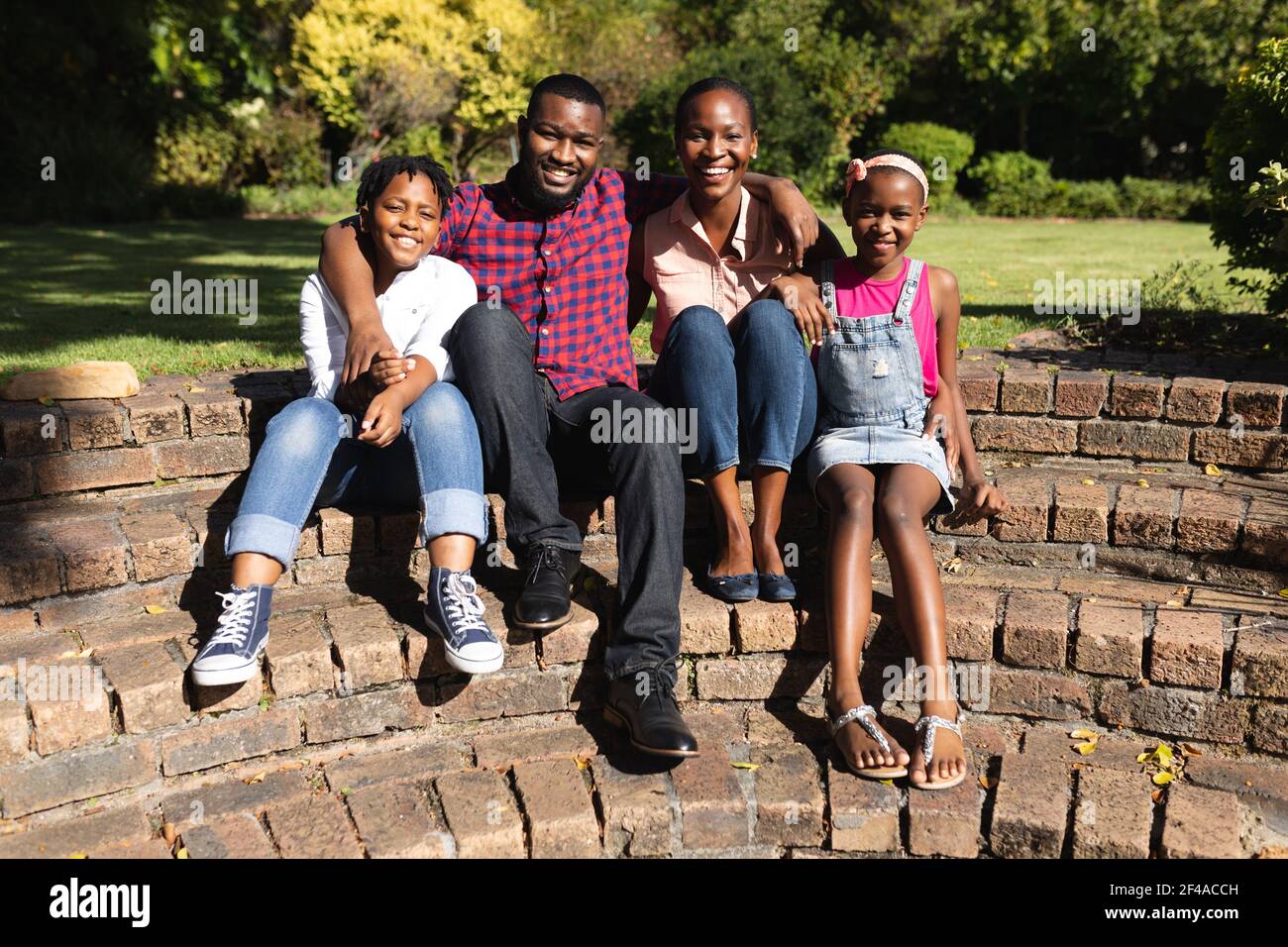 Smiling african american parents with daughter and son sitting ...