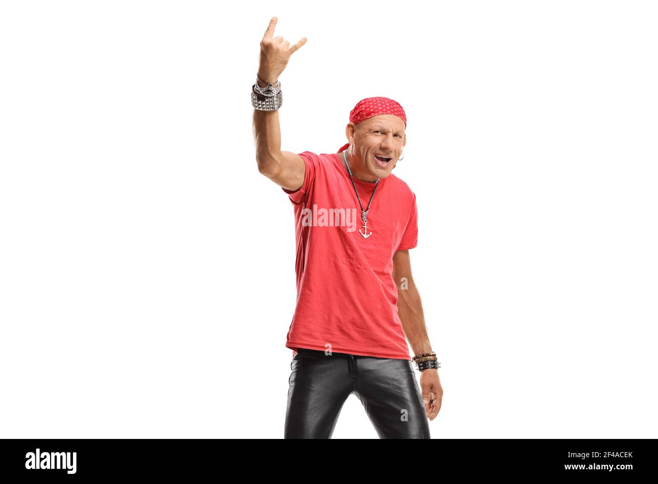 Rocker in leather pants making a rock and roll sign isolated on white ...