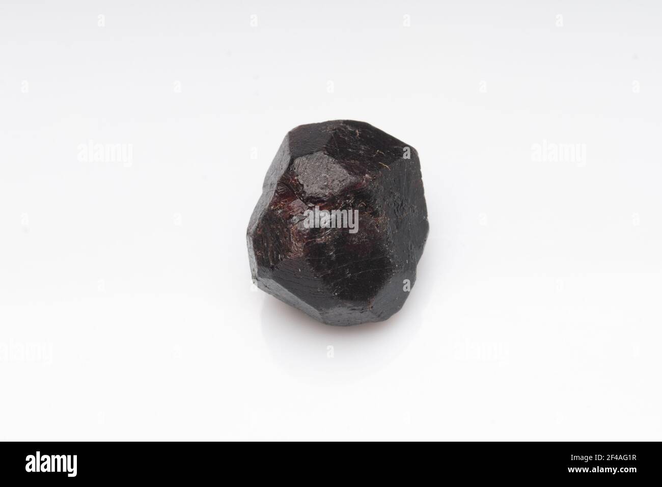 Natural stone garnet on white background Stock Photo - Alamy
