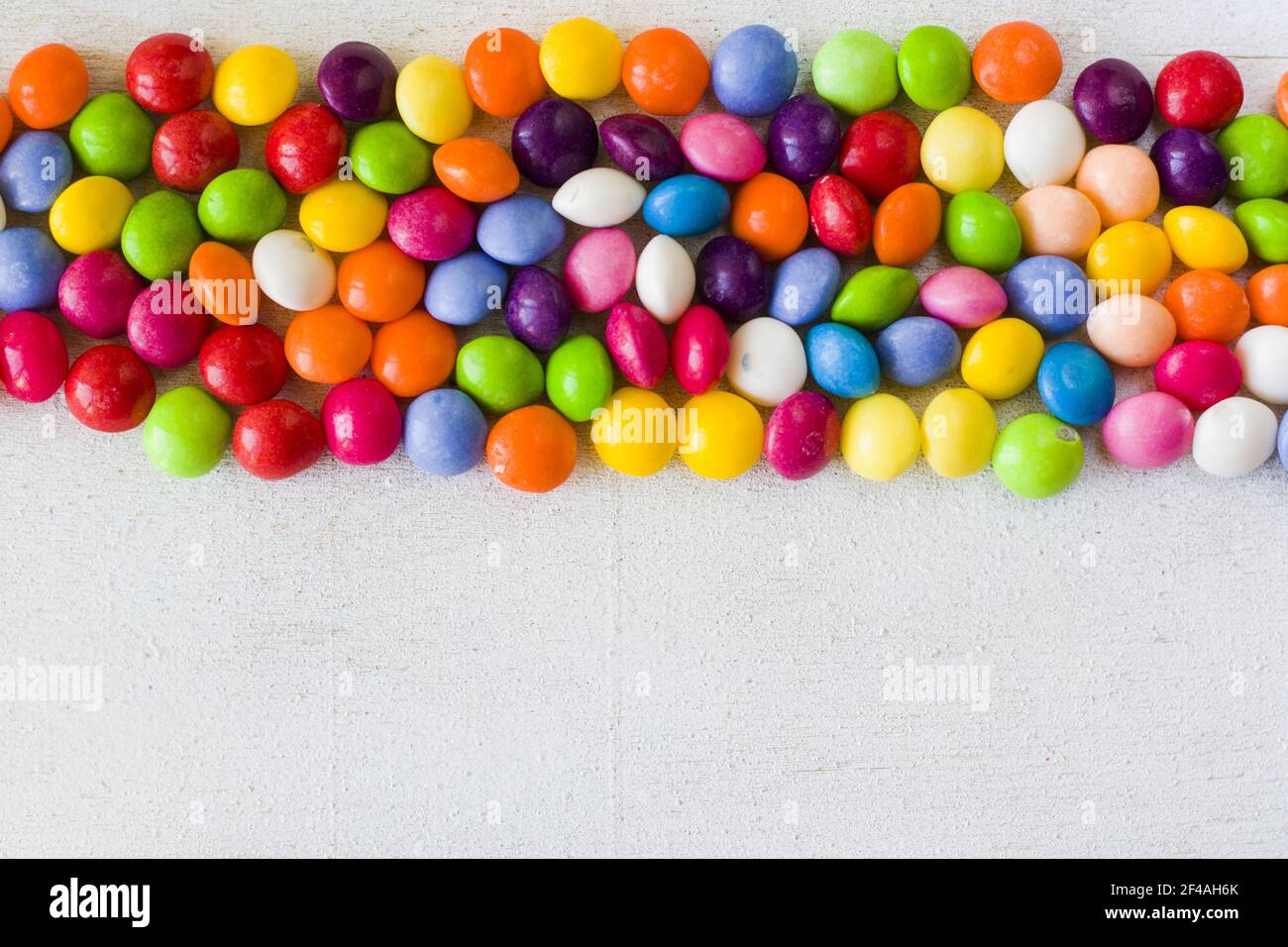 A closeup shot of colorful sweet candies isolated on a white background ...