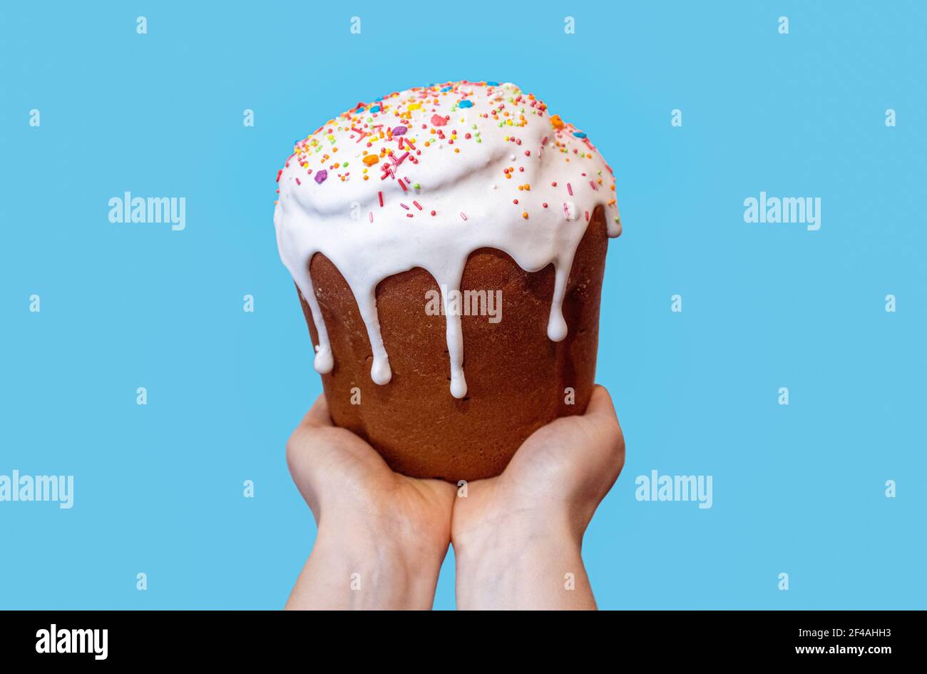 Hands holding easter traditional sweet bread, paska decorated with ...