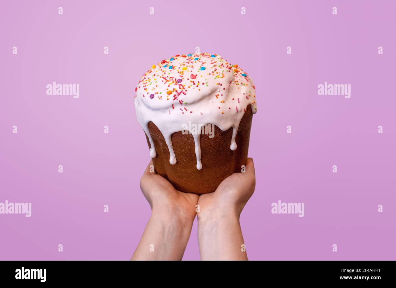 Hands holding easter traditional sweet bread, paska decorated with ...