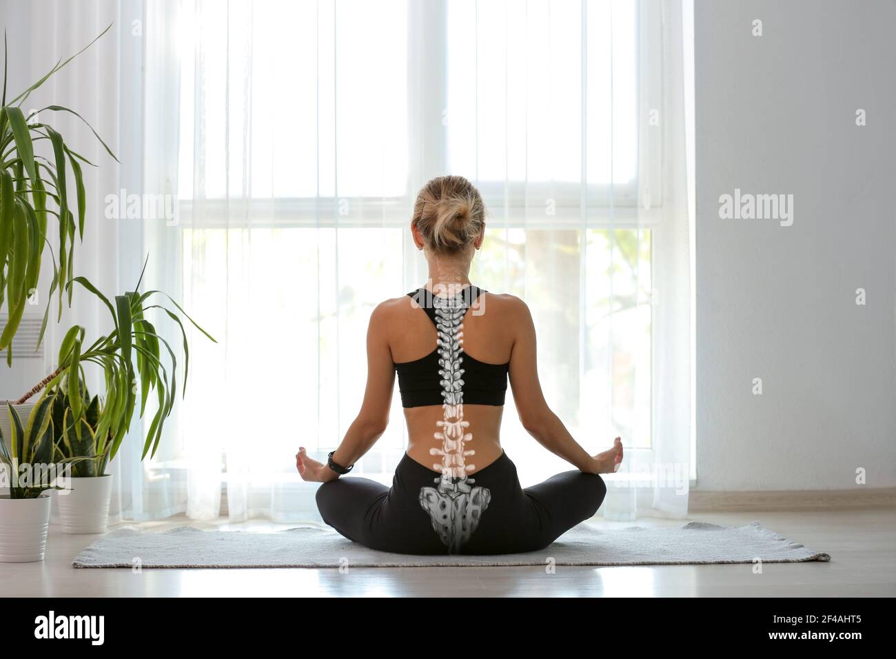 Young woman with good posture meditating at home, back view Stock Photo ...