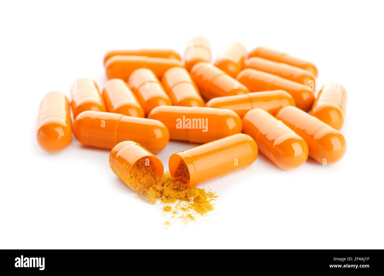 Turmeric pills on white background Stock Photo - Alamy