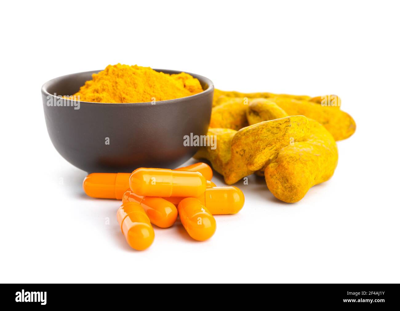 Turmeric pills and bowl with powder on white background Stock Photo - Alamy