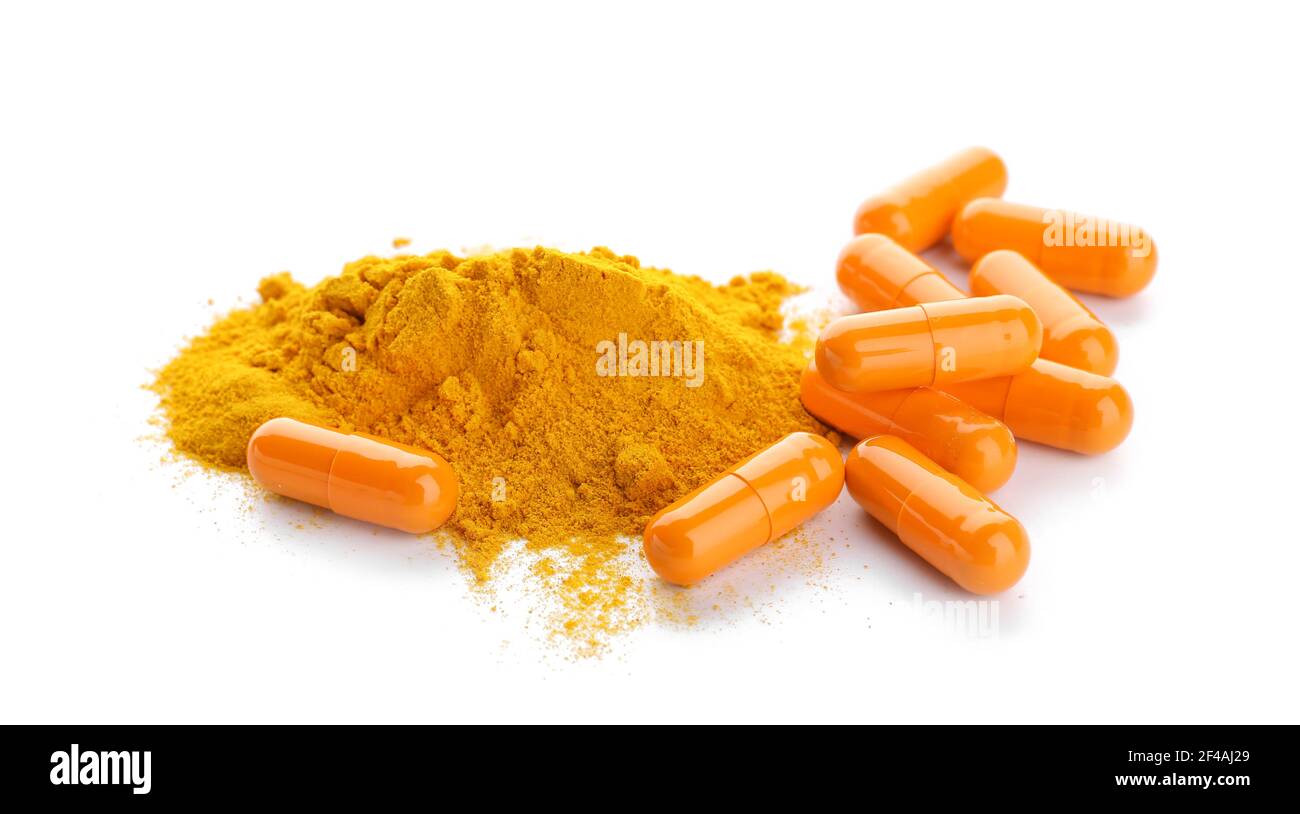 Turmeric pills and powder on white background Stock Photo - Alamy