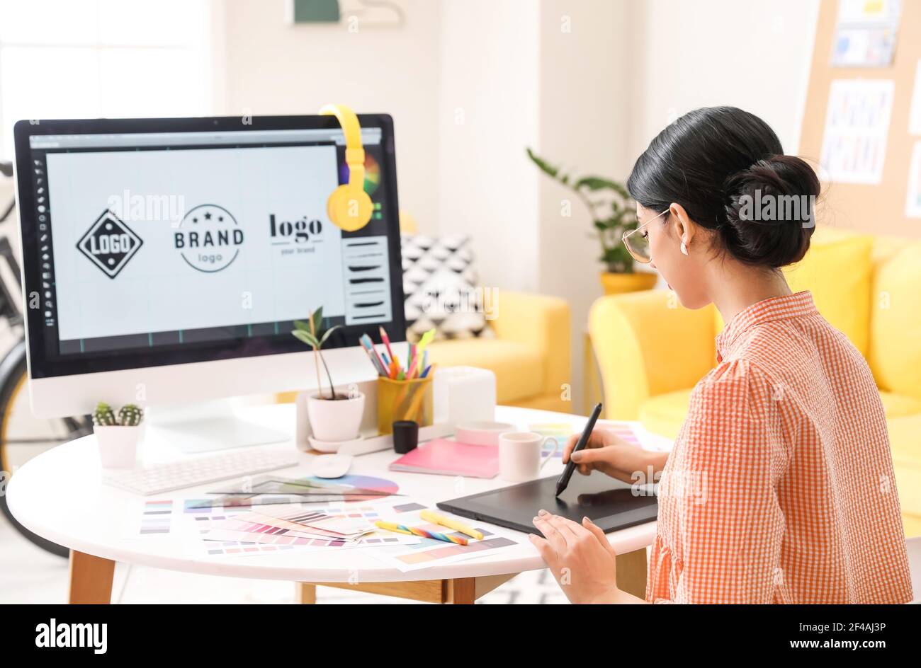 Graphic designer working in office Stock Photo - Alamy
