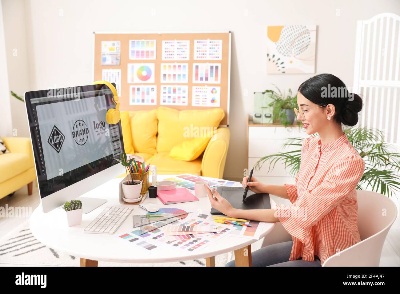 Graphic designer working in office Stock Photo - Alamy