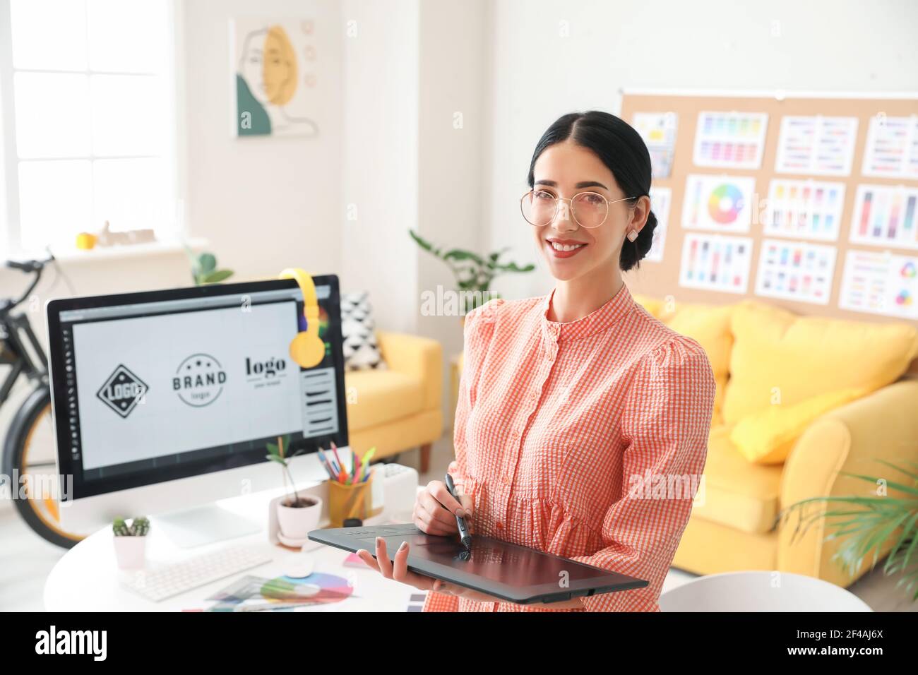 Graphic designer working in office Stock Photo - Alamy