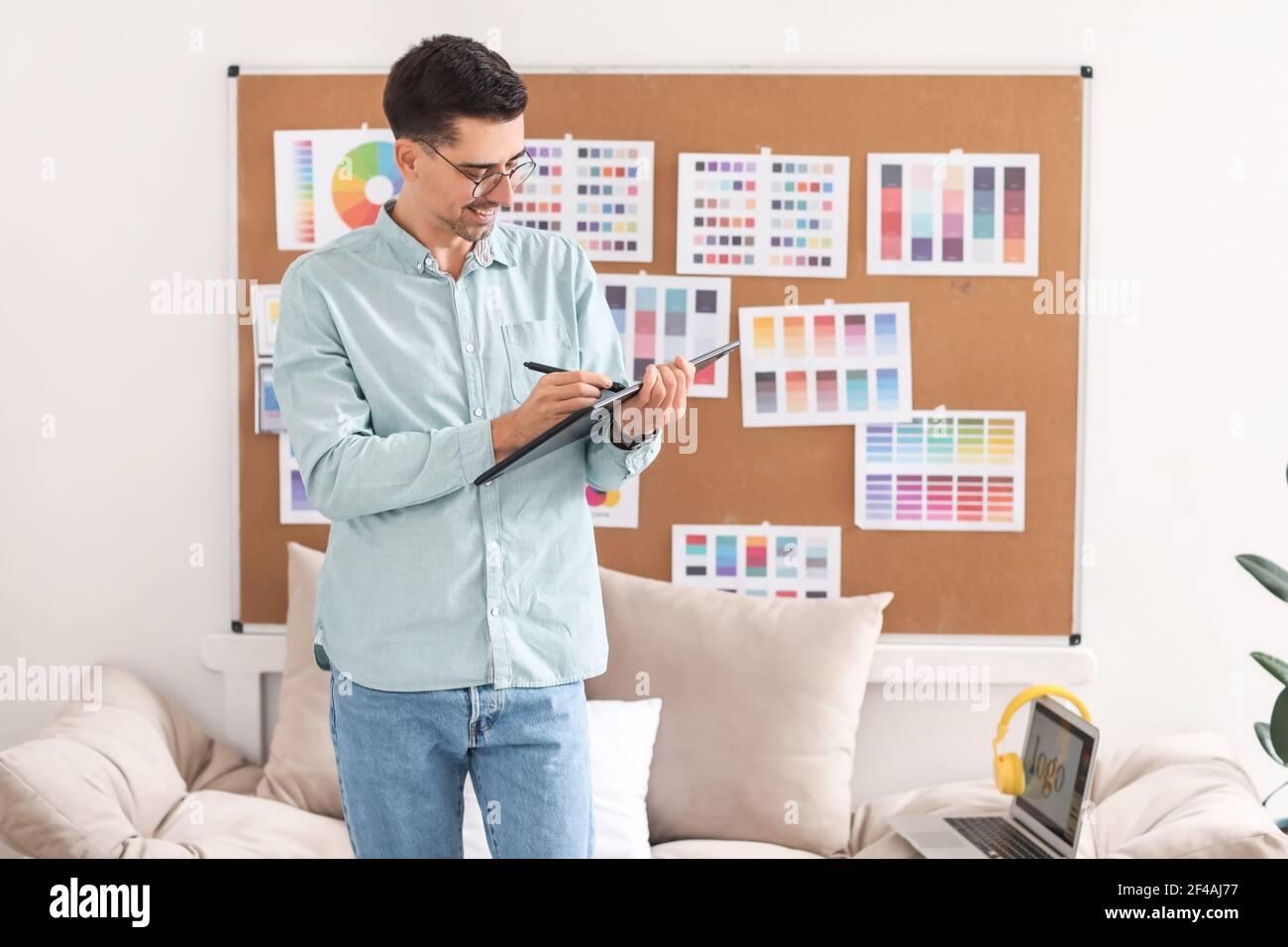 Graphic designer working in office Stock Photo - Alamy