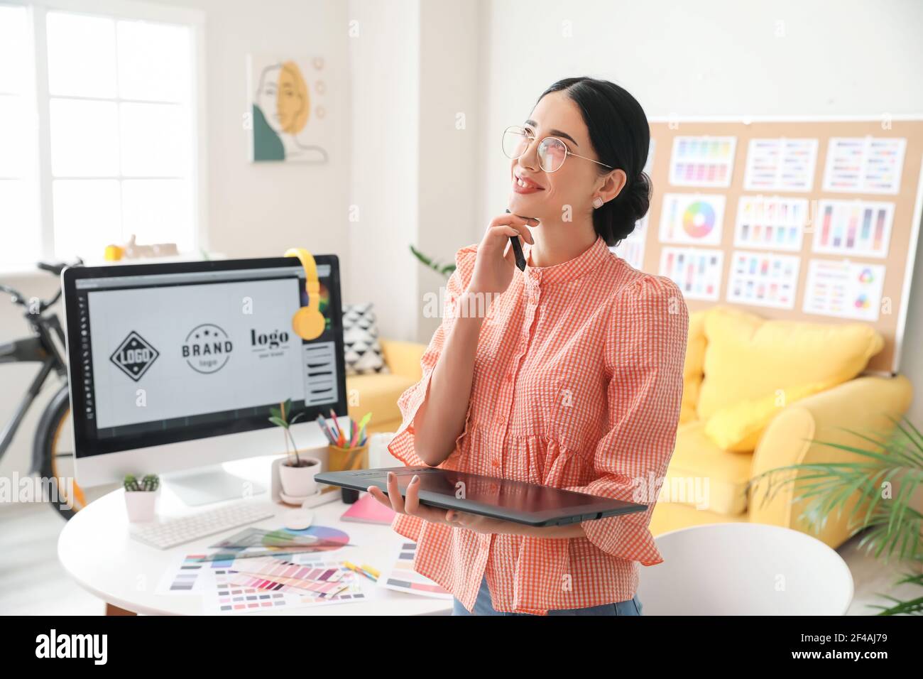 Graphic designer working in office Stock Photo - Alamy