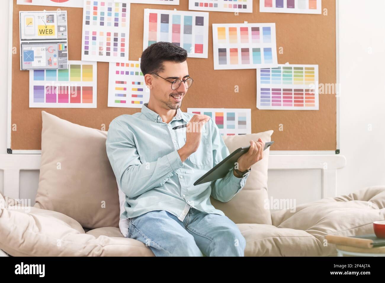 Graphic designer working in office Stock Photo - Alamy