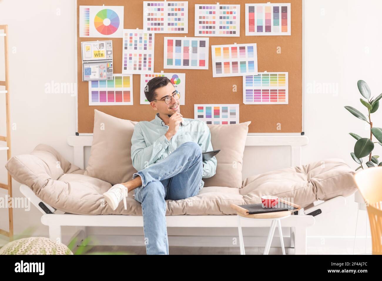 Graphic designer working in office Stock Photo - Alamy