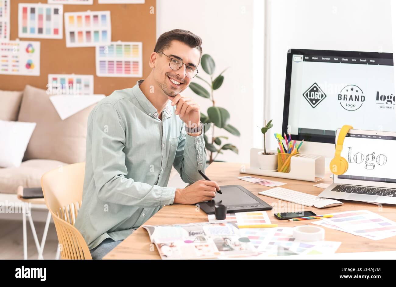 Graphic designer working in office Stock Photo - Alamy