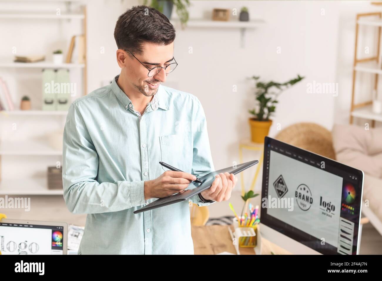 Graphic designer working in office Stock Photo - Alamy