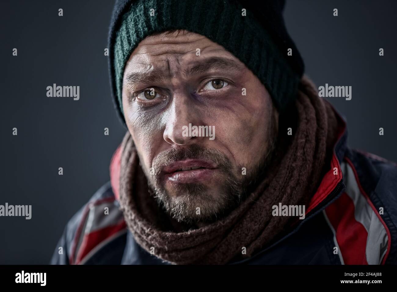 Portrait of poor homeless man on dark background Stock Photo - Alamy