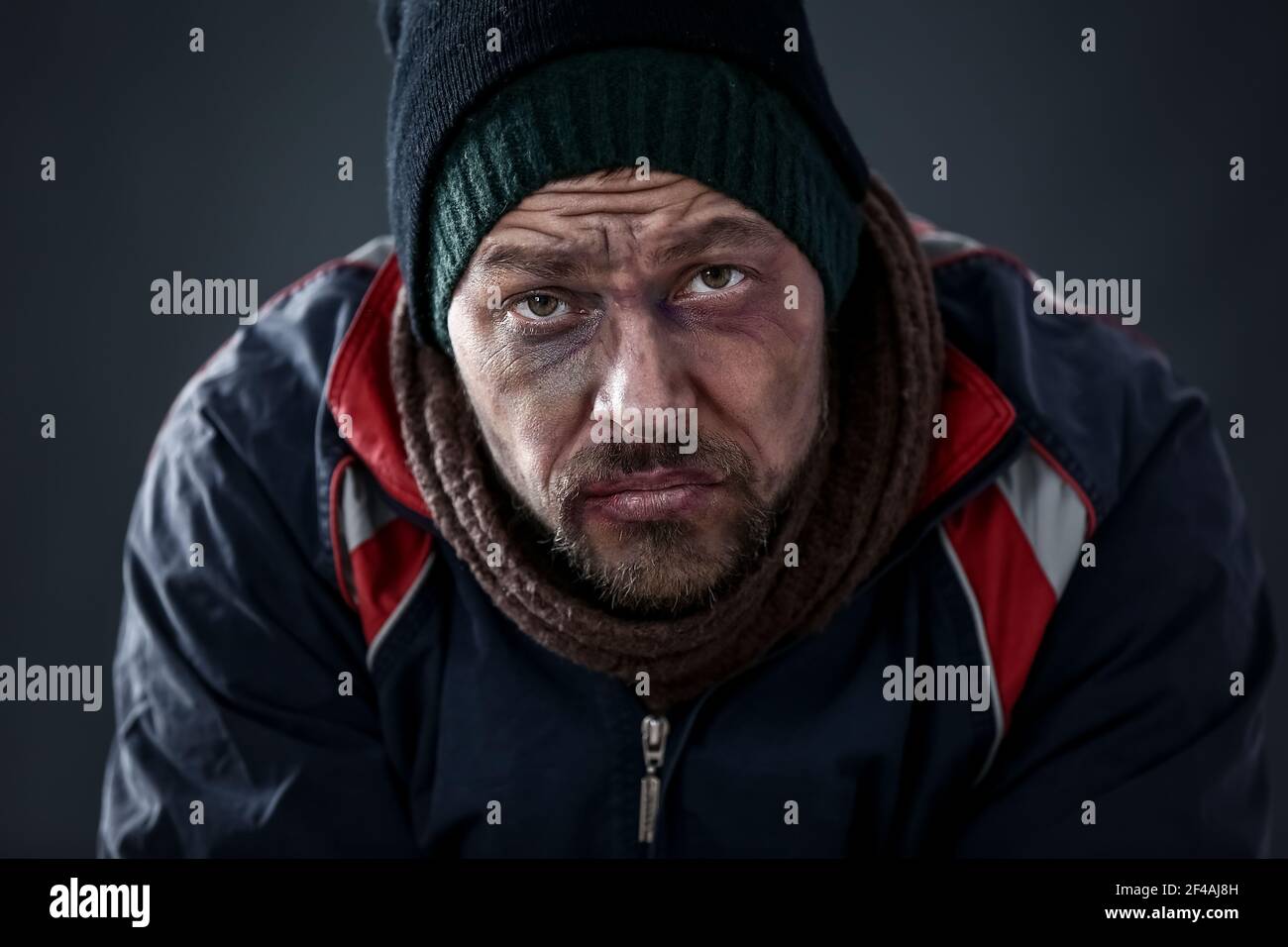 Portrait of poor homeless man on dark background Stock Photo - Alamy
