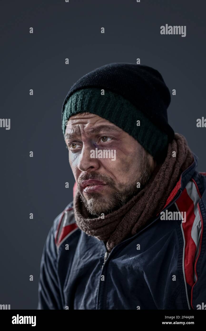 Portrait of poor homeless man on dark background Stock Photo - Alamy