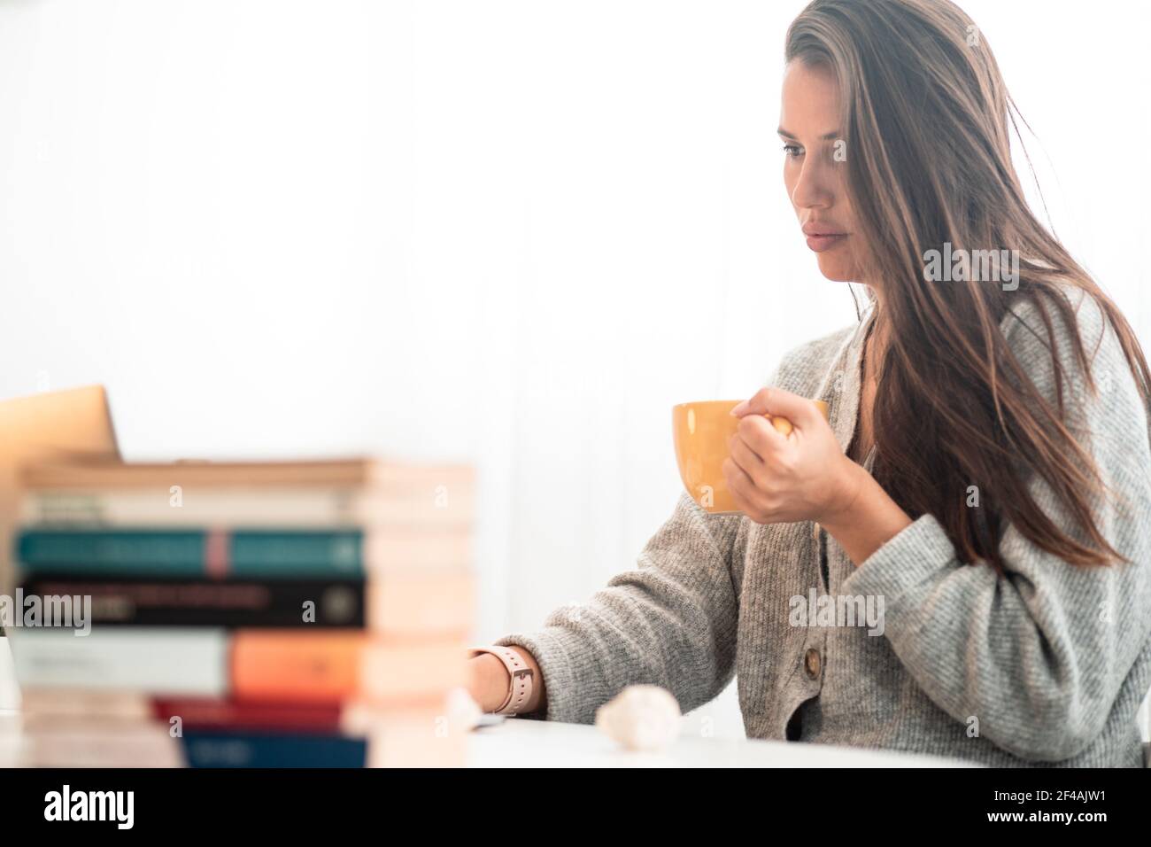young woman teleworking at home with computer drinking coffee Stock ...