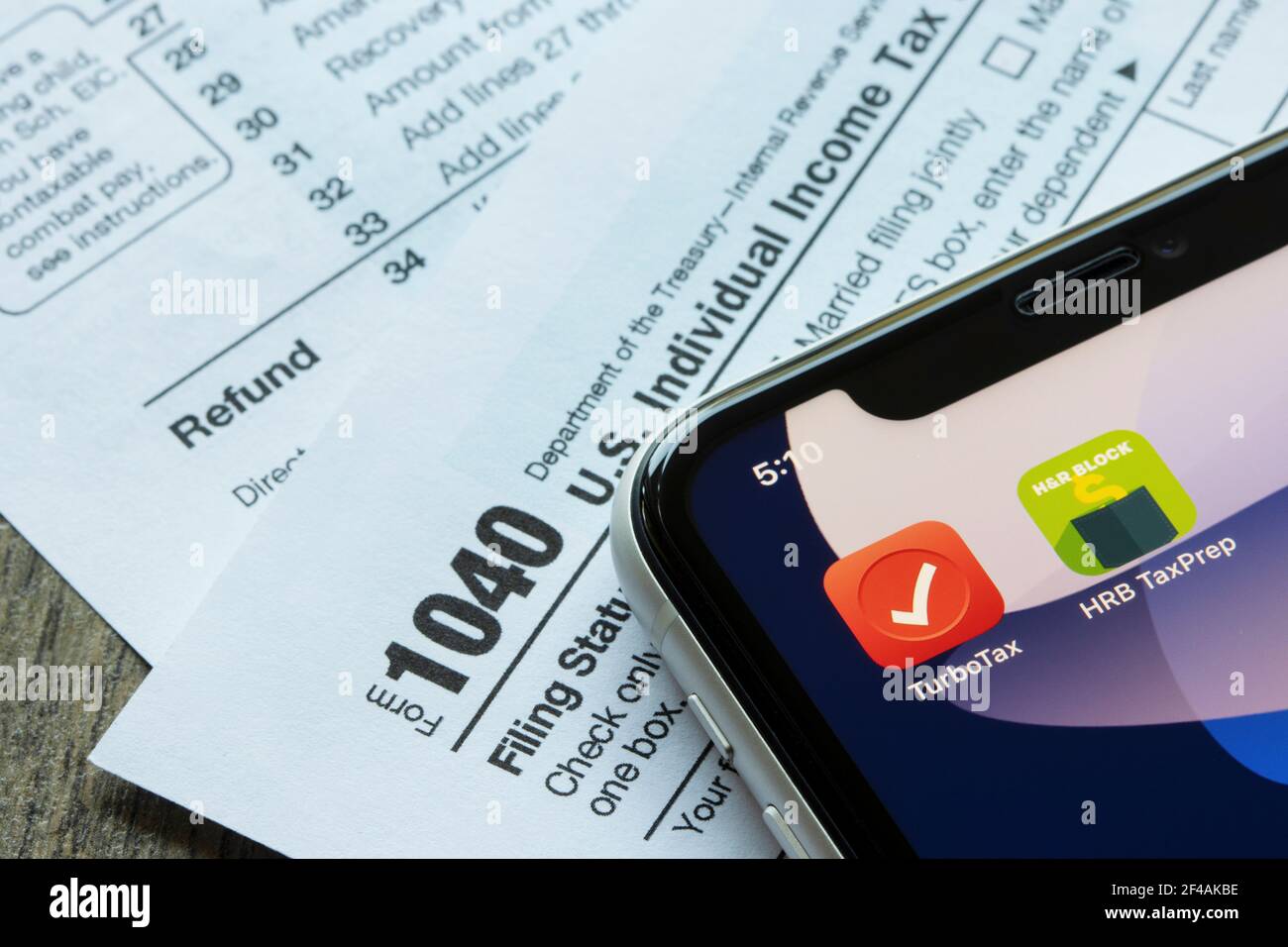 TurboTax and HRB Tax Prep mobile app icons are seen on an iPhone, with ...