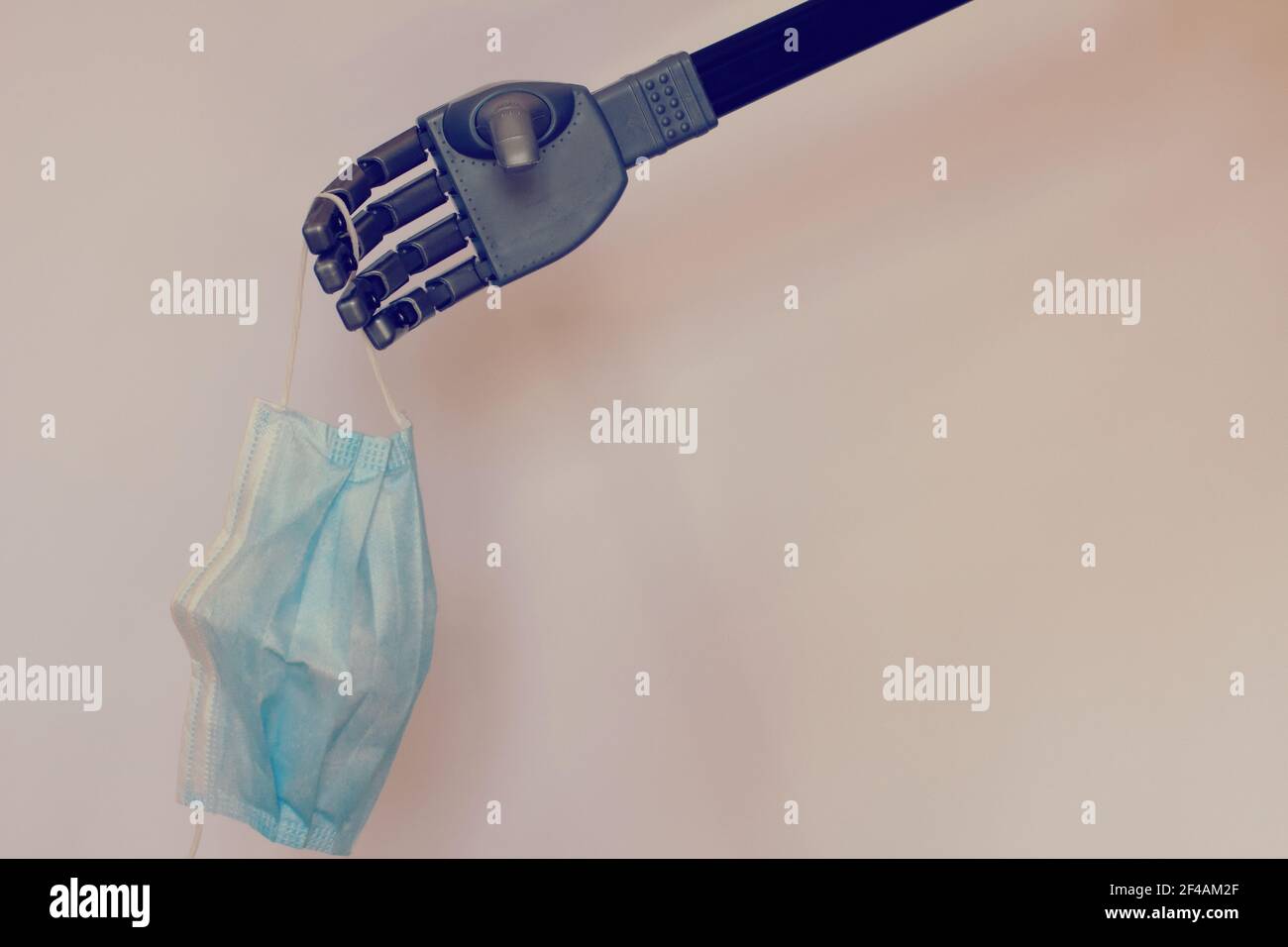 Robot hand holding a face mask Stock Photo - Alamy