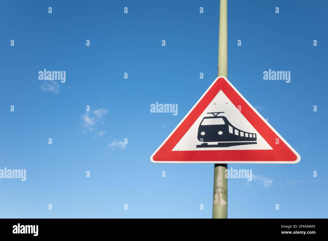 Train black symbol on rectangular red and white sign on pole at railway ...