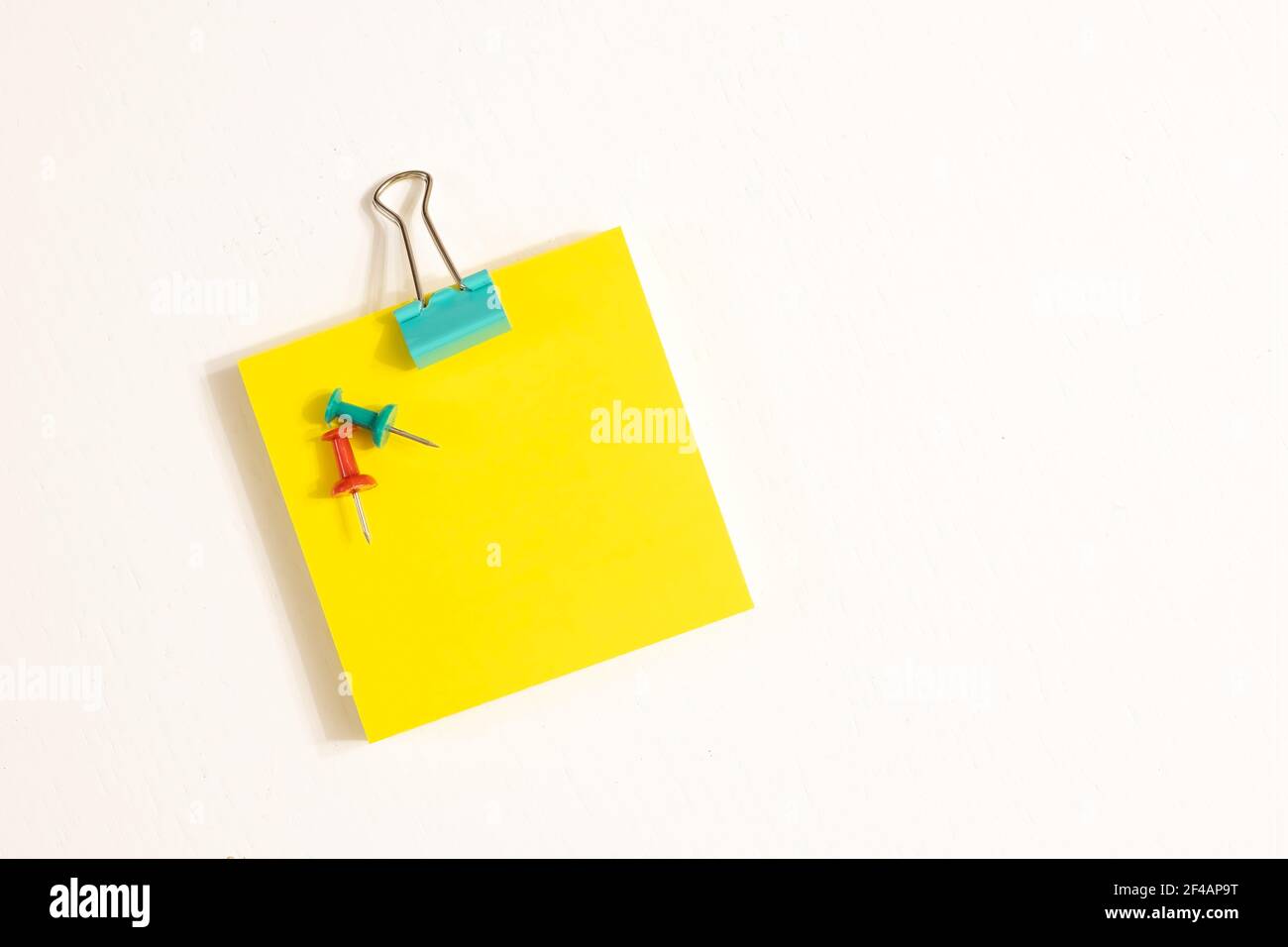 Green Binder Clips, Pins and Yellow Sticky Notes Isolated on White ...