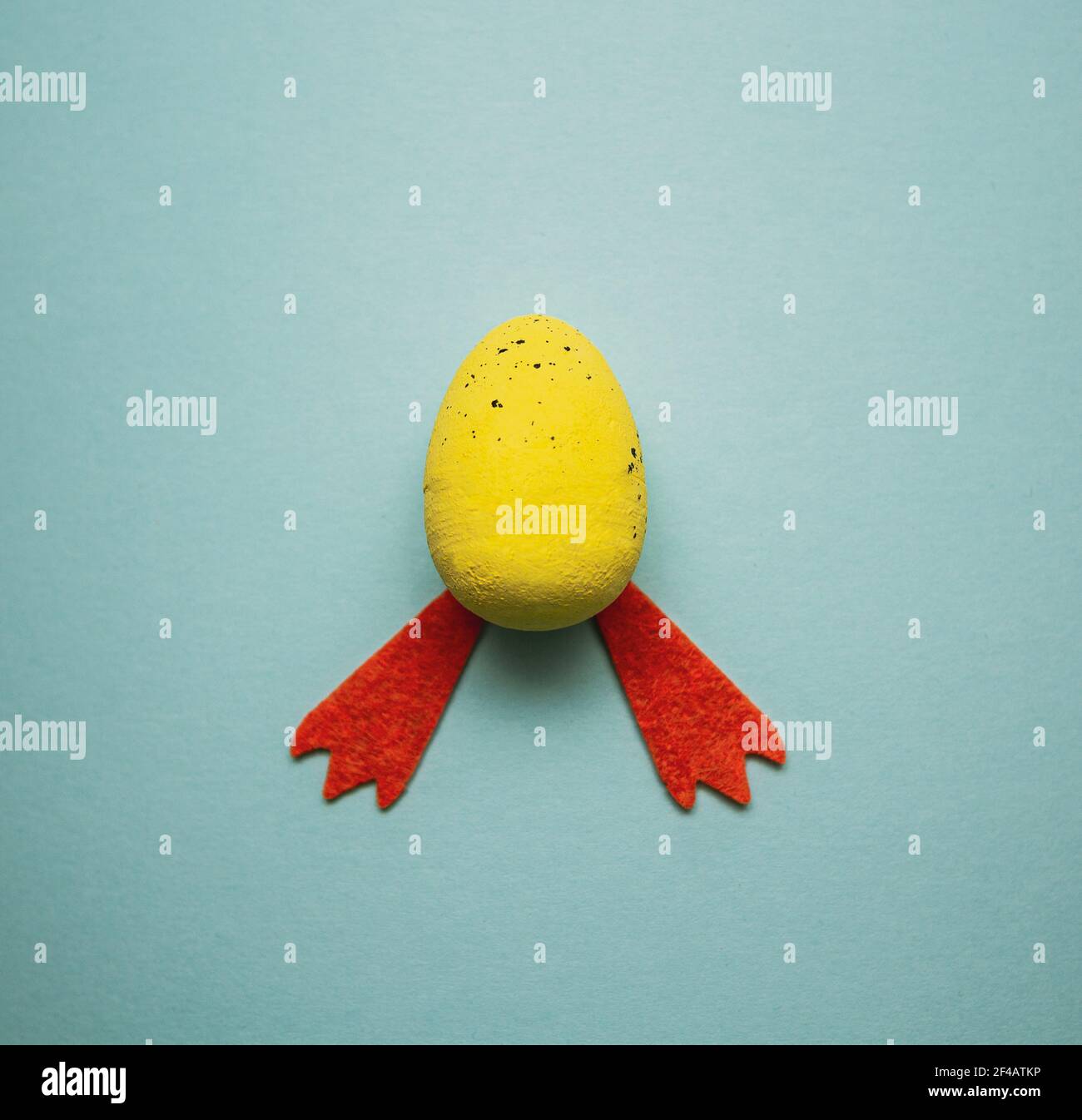 Easter chick made of yellow Easter egg and cotton chicken legs. Minimal ...