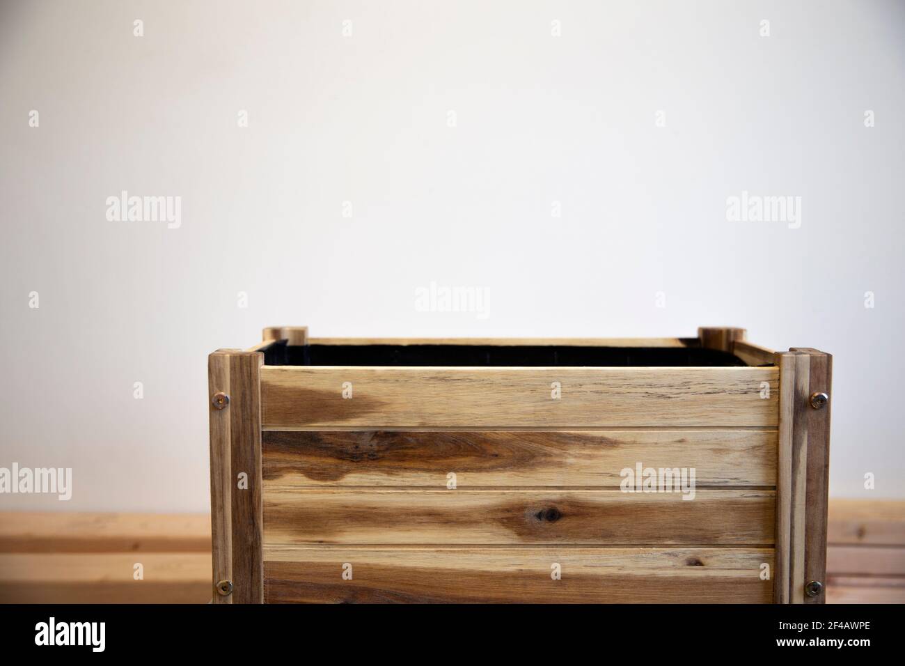 wooden empty rectangular pot for plants on white wall background ...
