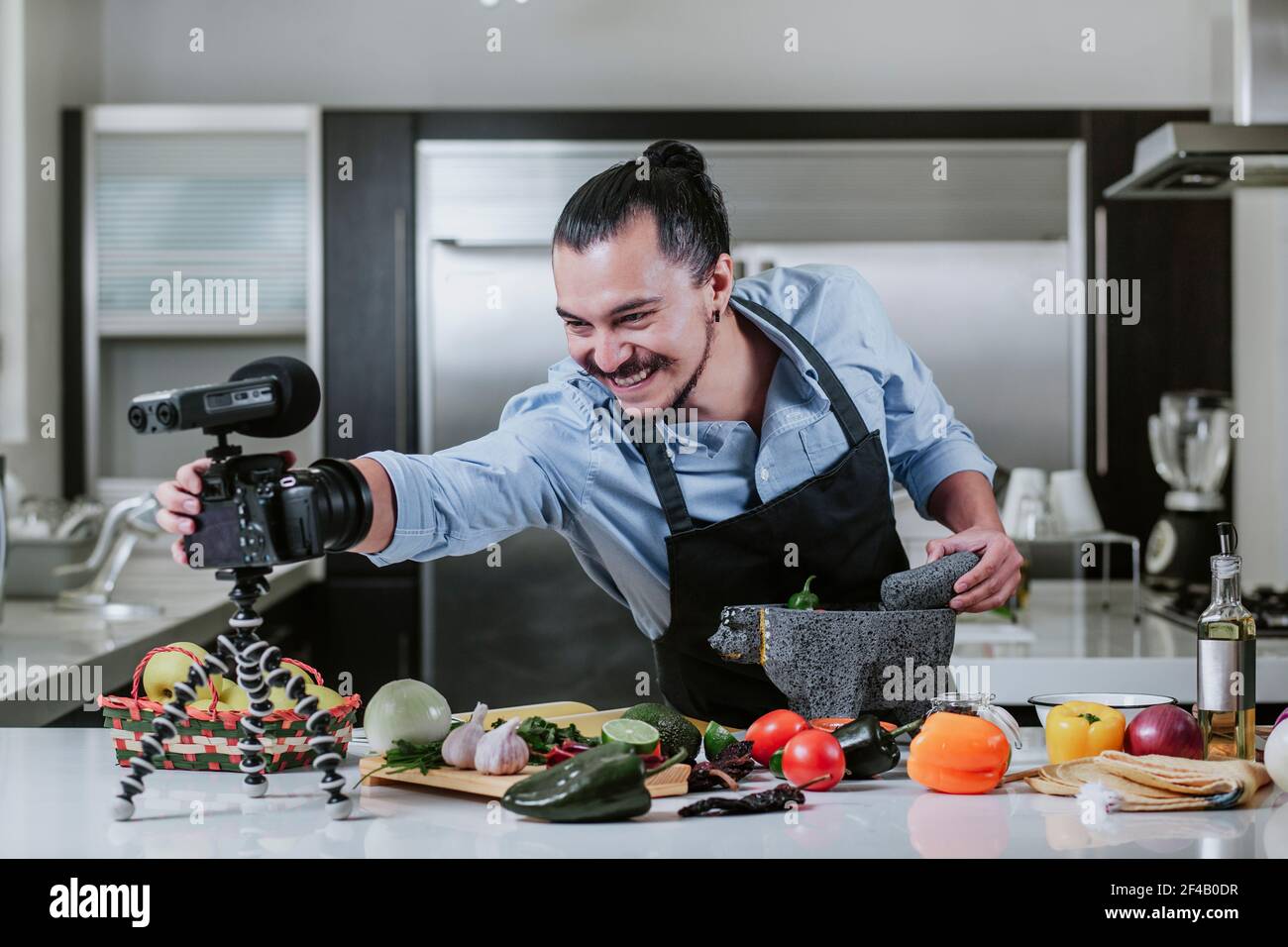 latin man food blogger preparing mexican sauce, cooking and culinary ...