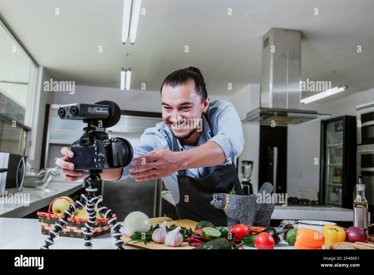 latin man food blogger preparing mexican sauce, cooking and culinary ...